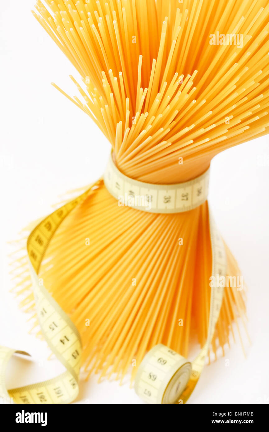 Spaghetti with measuring tape Stock Photo - Alamy