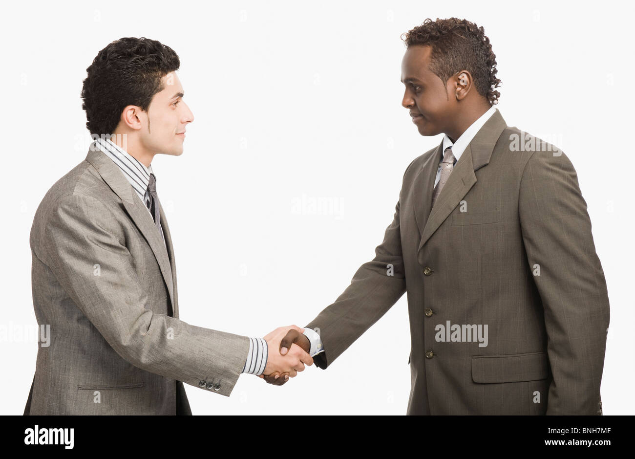 Two businessmen shaking hands Stock Photo - Alamy