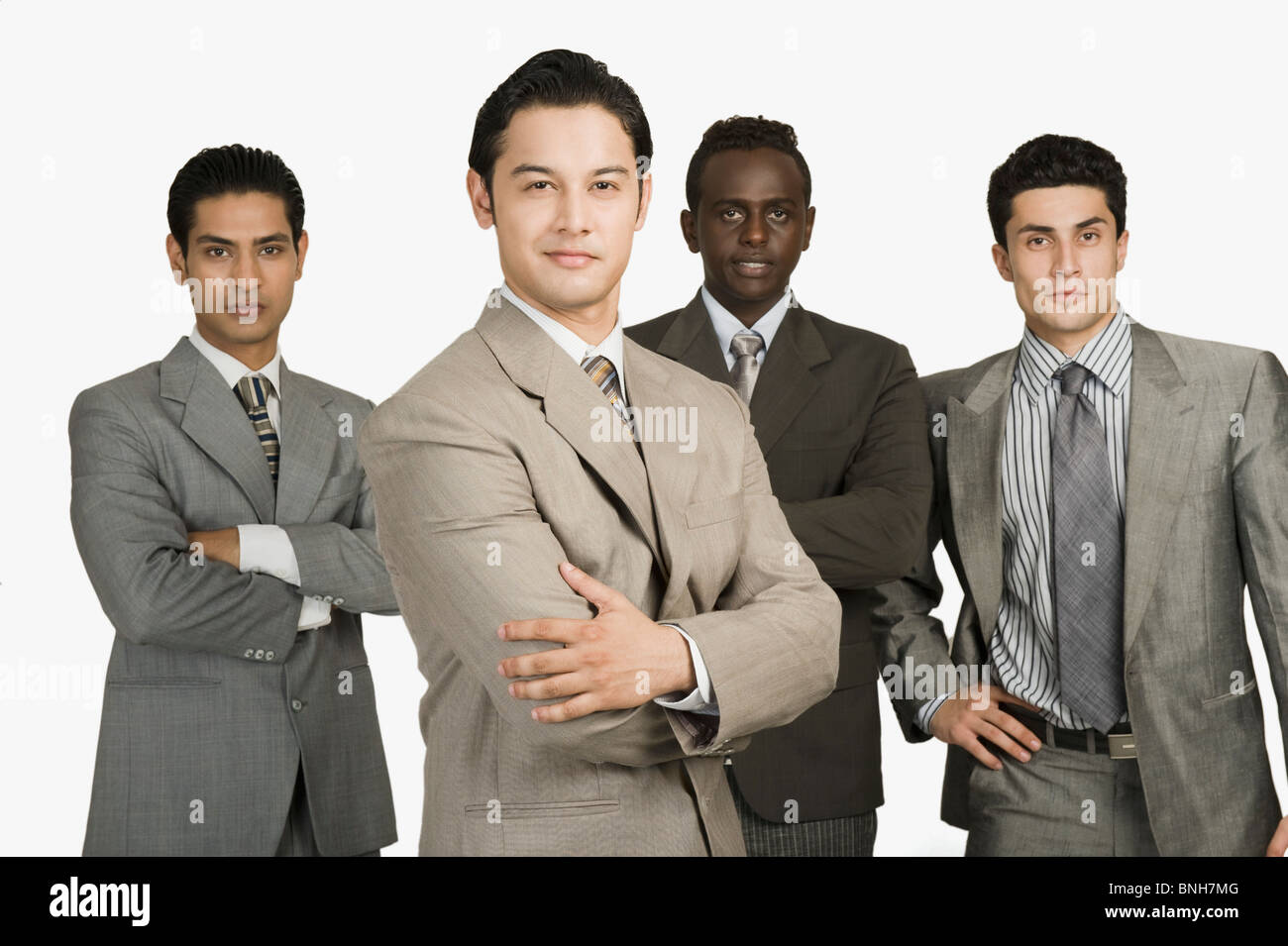 Portrait of four businessmen standing together Stock Photo - Alamy