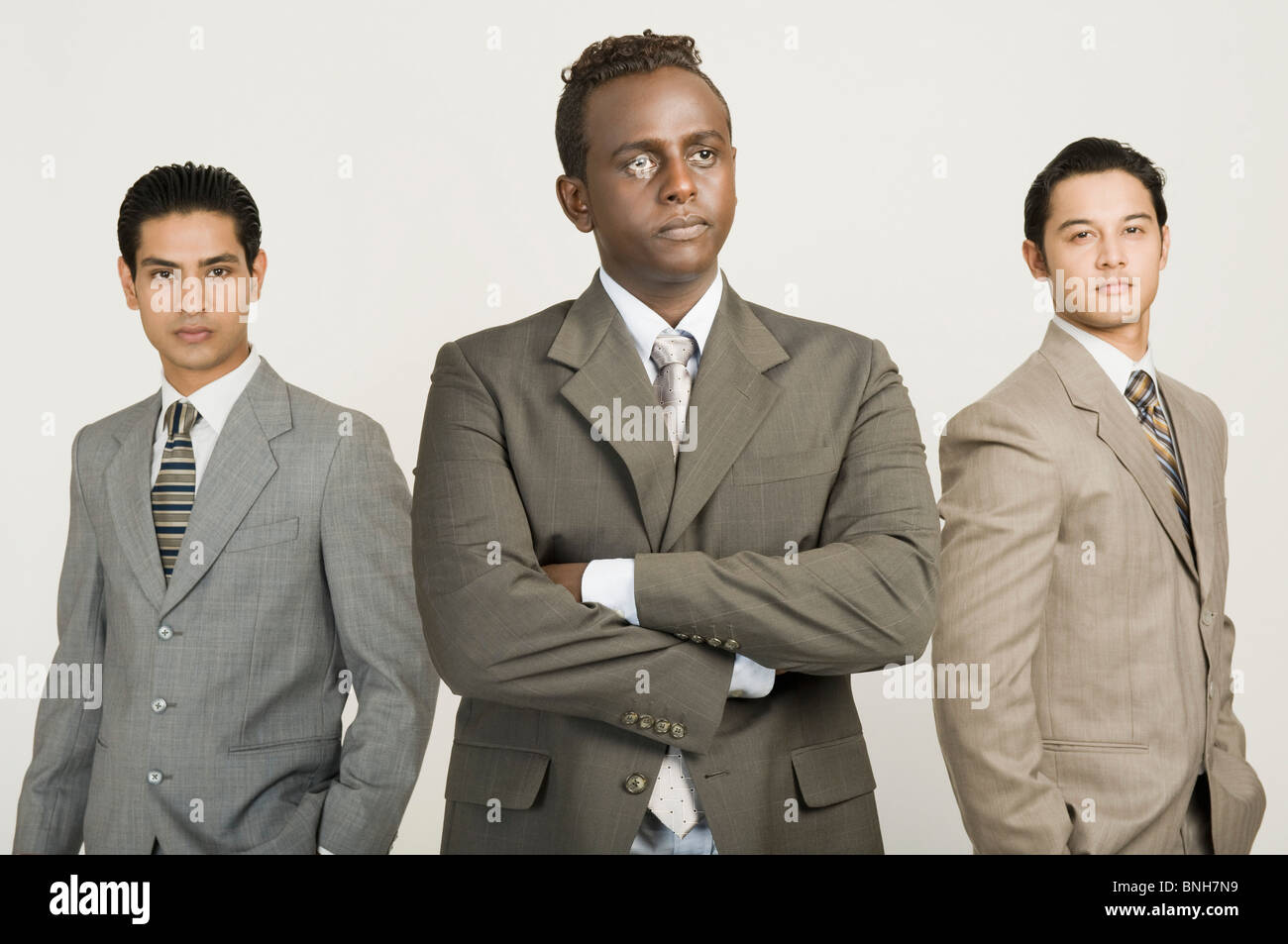 Three businessmen standing together Stock Photo - Alamy