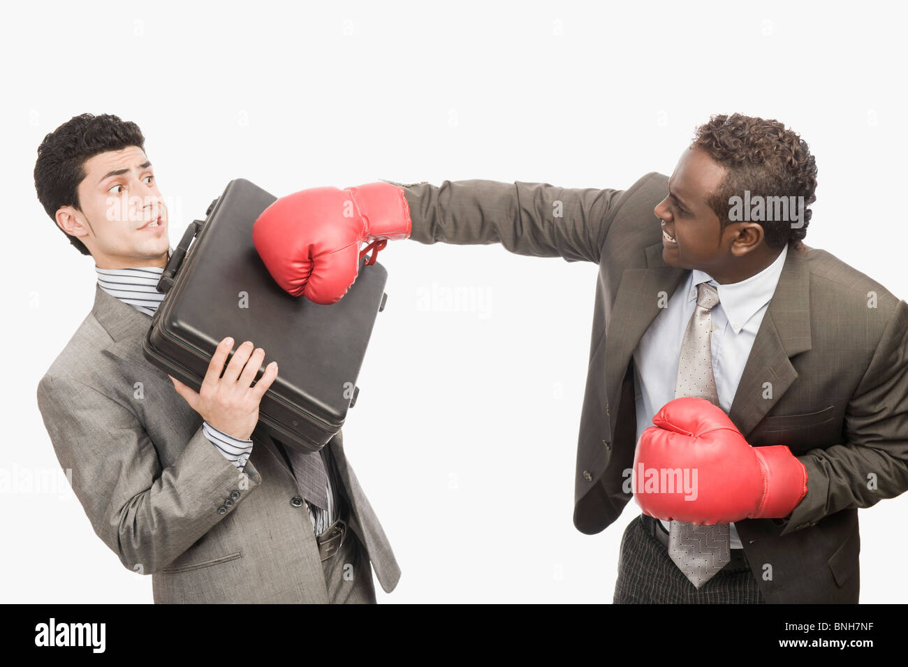 Businessman defending himself from the punch of his colleague Stock ...