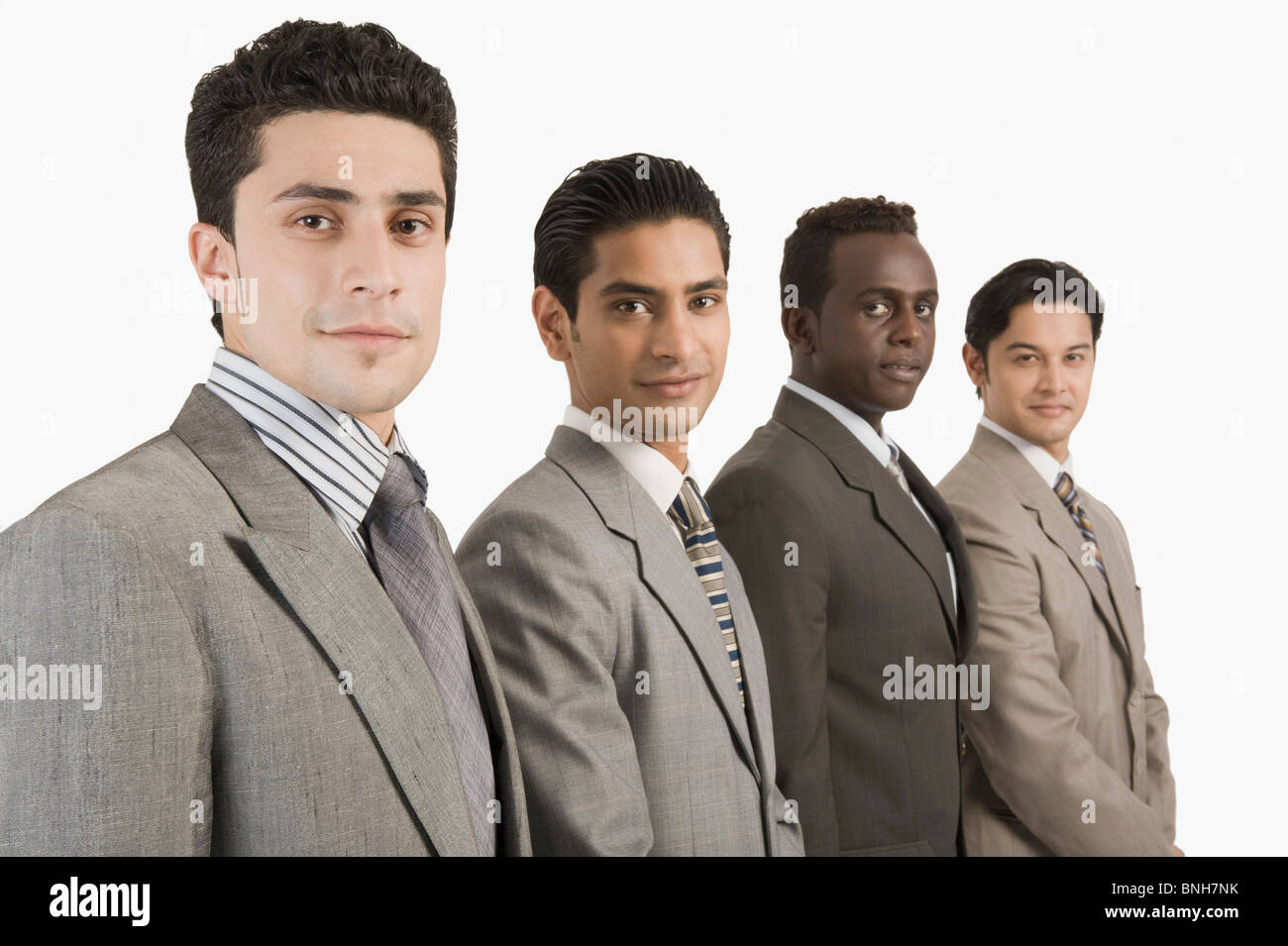 Portrait of four businessmen standing together Stock Photo - Alamy
