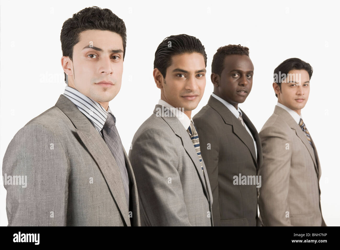 Portrait of four businessmen standing together Stock Photo - Alamy