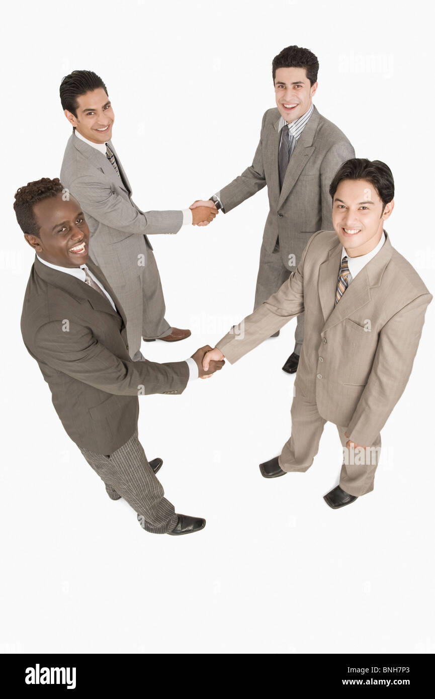 Four businessmen shaking hands Stock Photo - Alamy