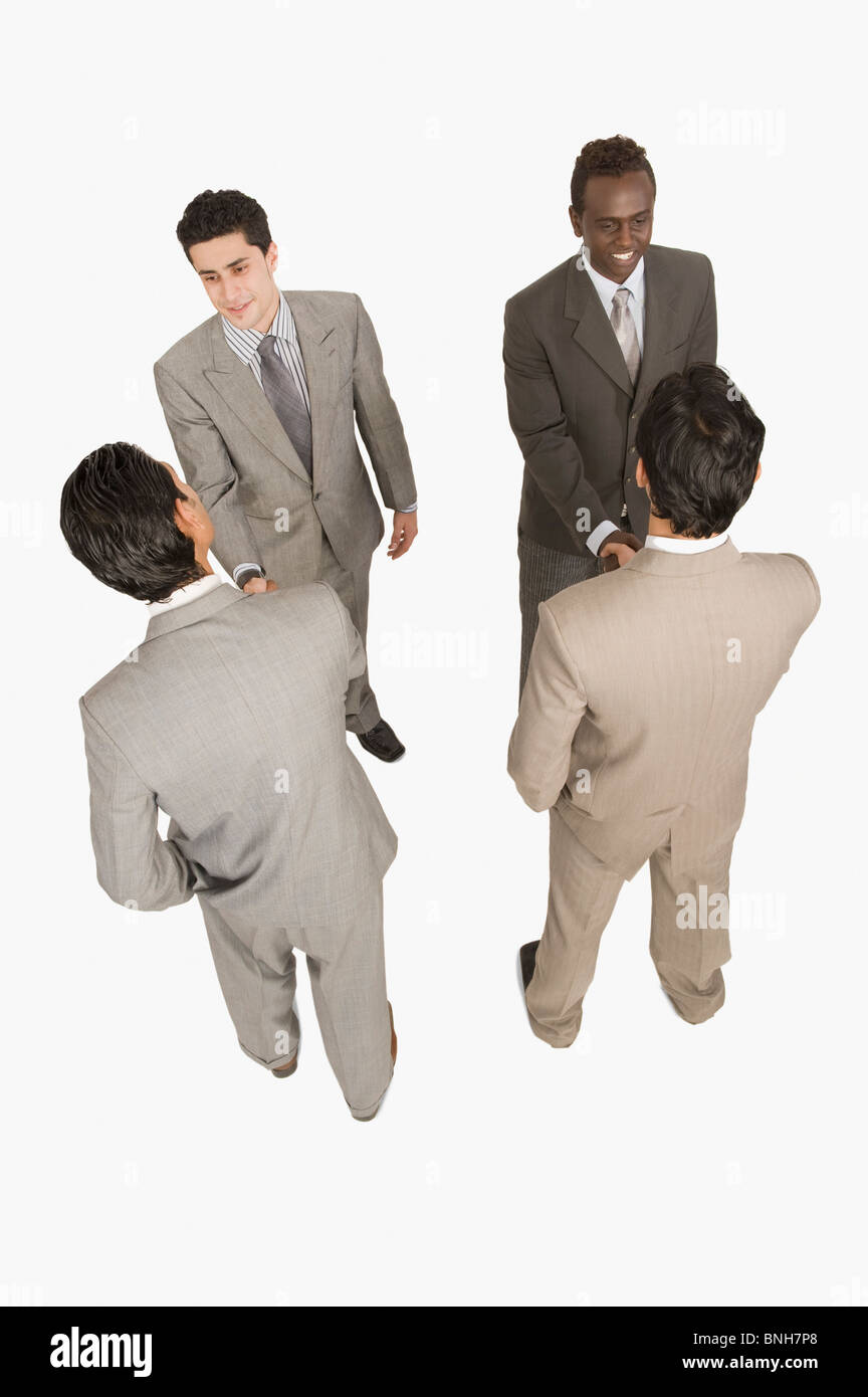 Four businessmen shaking hands Stock Photo - Alamy
