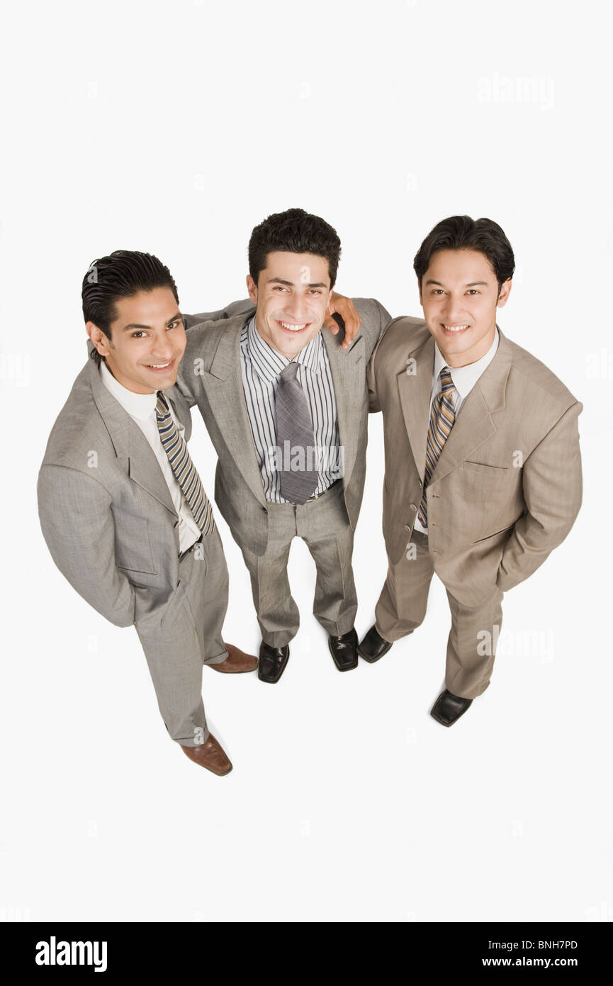 Portrait of three businessmen smiling Stock Photo - Alamy