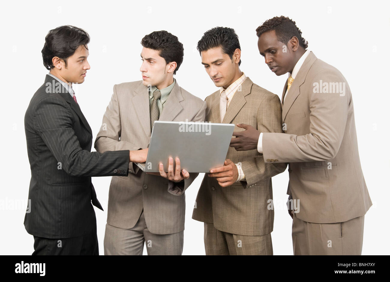 Four businessmen standing with a laptop Stock Photo - Alamy Four businessmen standing with a laptop Stock Photo - Alamy