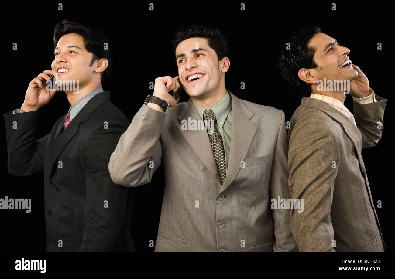 Three businessmen talking on mobile phones Stock Photo - Alamy
