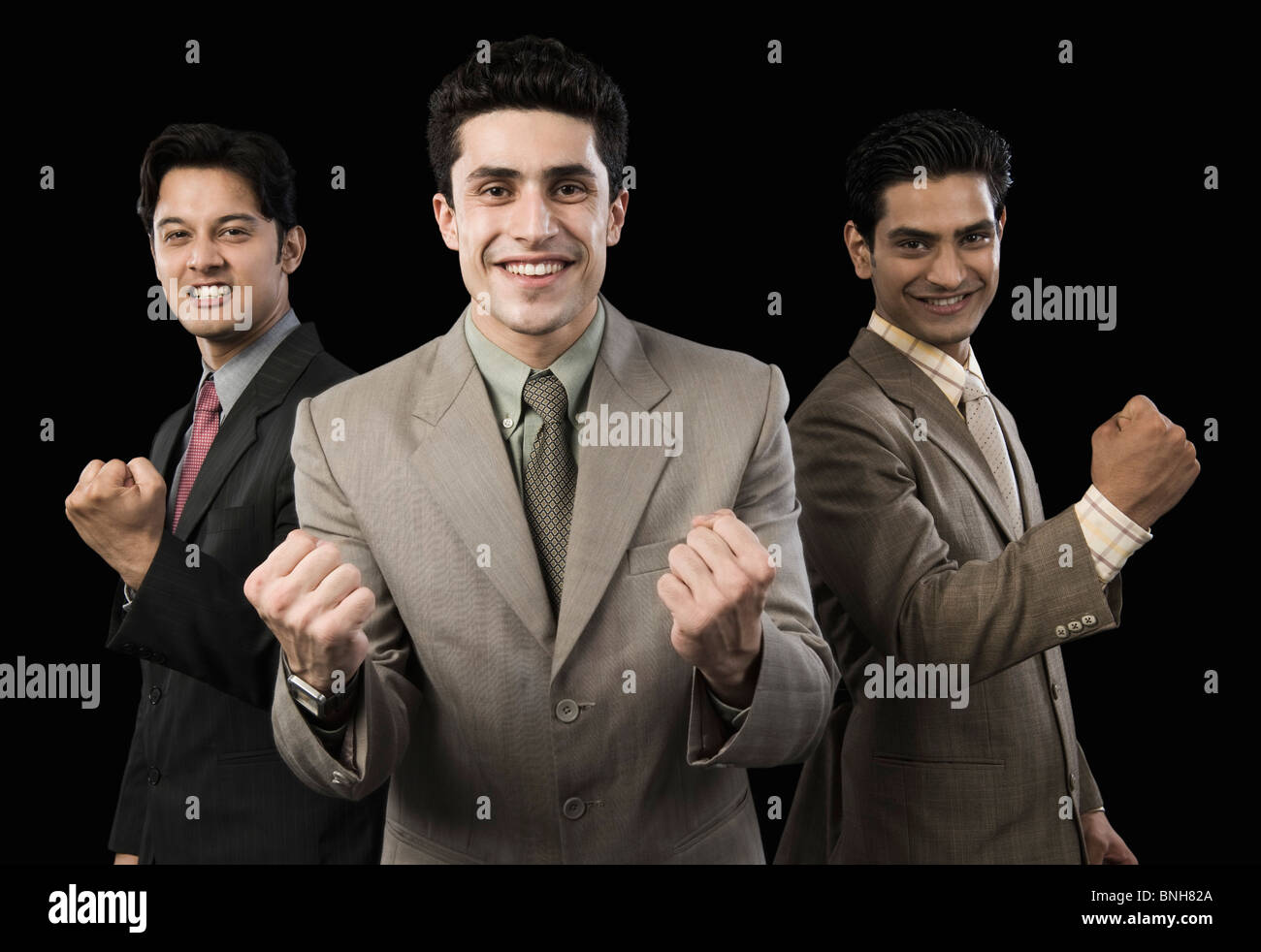 Portrait of three businessmen cheering Stock Photo - Alamy