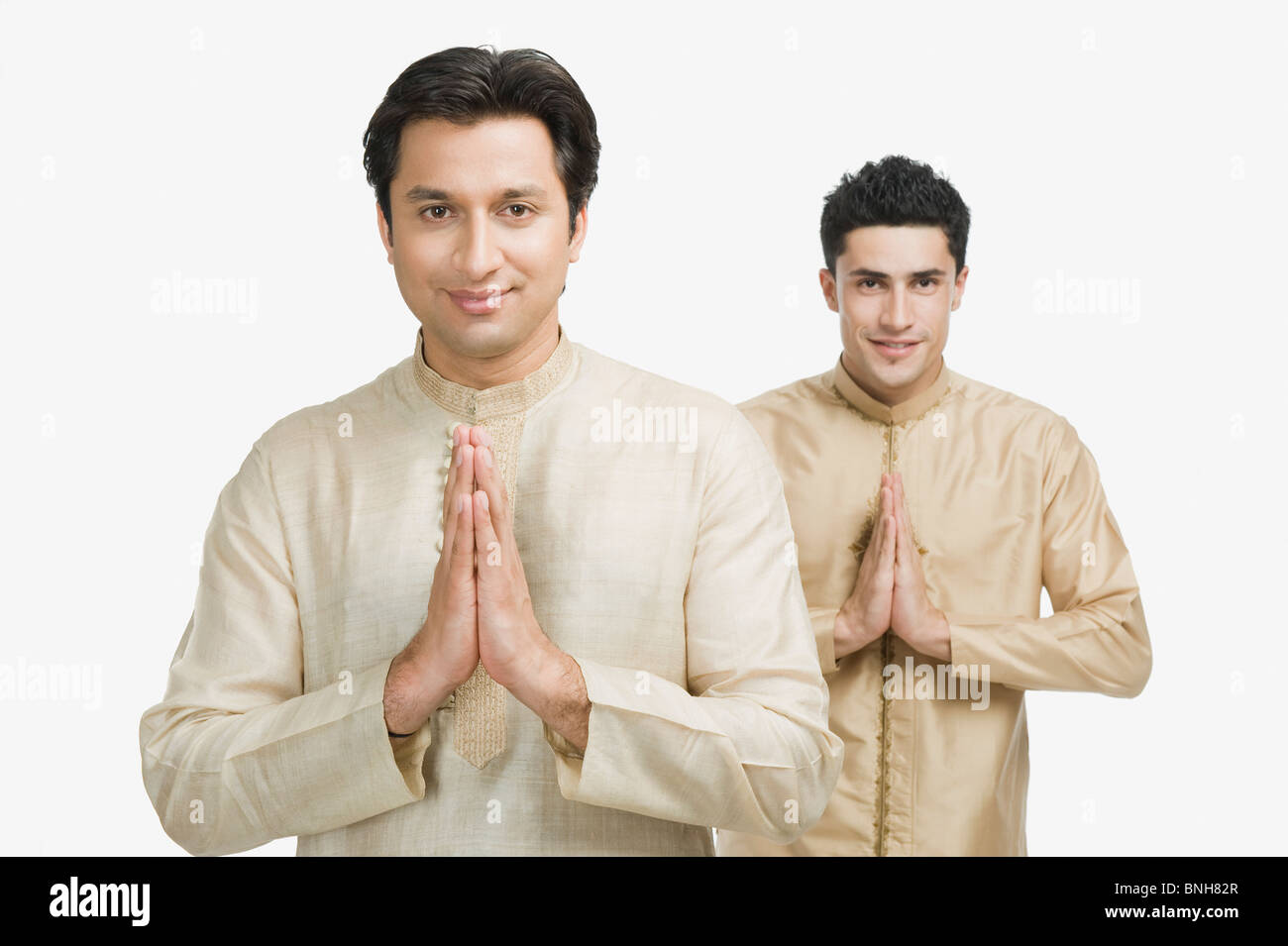 Two men in prayer position Stock Photo - Alamy