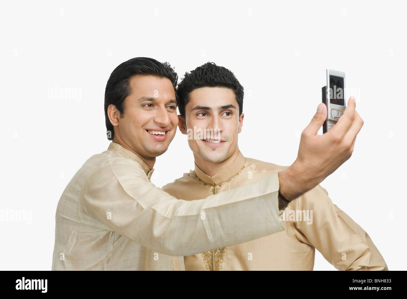Two men taking a picture of themselves with a mobile phone Stock Photo ...