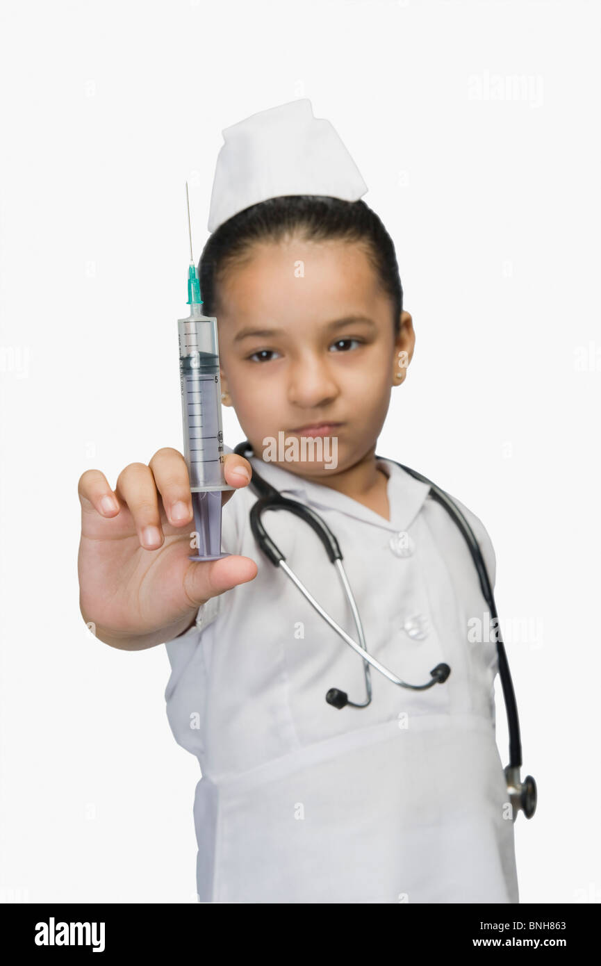 Girl dressed as a nurse and holding a syringe Stock Photo - Alamy
