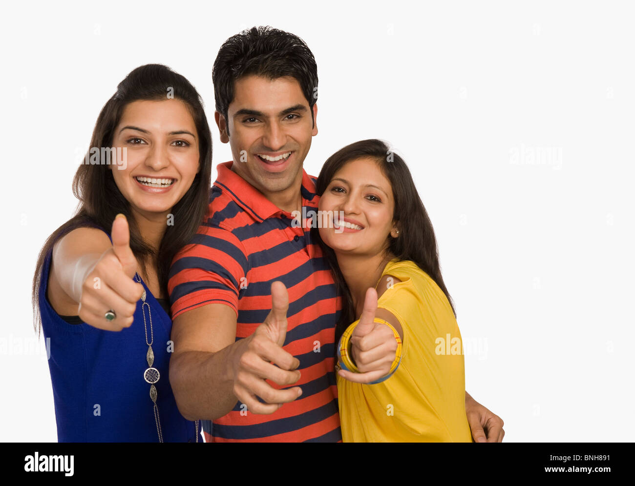Portrait of three friends showing thumbs up sign Stock Photo - Alamy