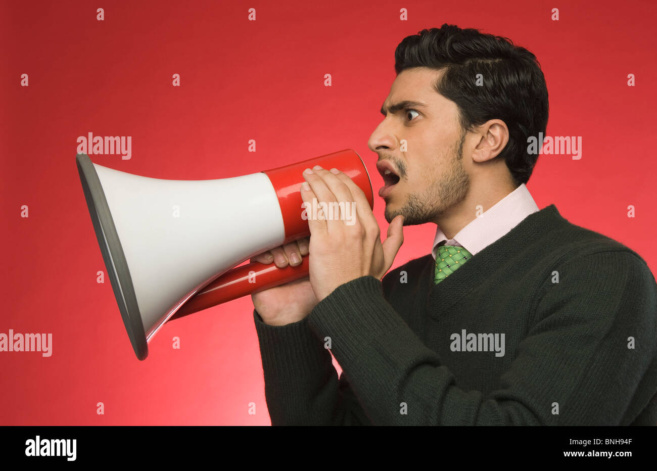Businessman shouting into a megaphone Stock Photo - Alamy