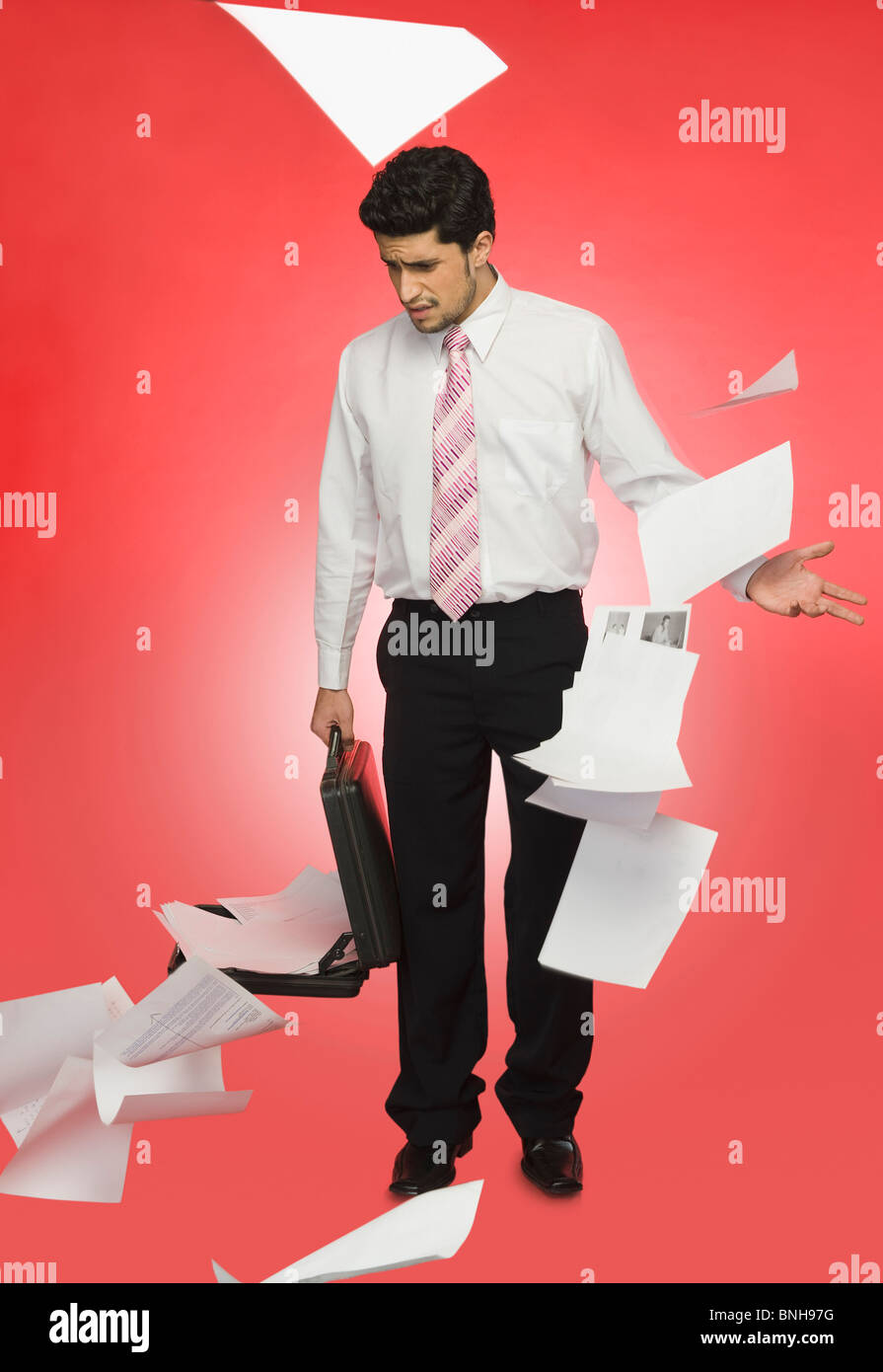 Businessman holding an open briefcase Stock Photo - Alamy