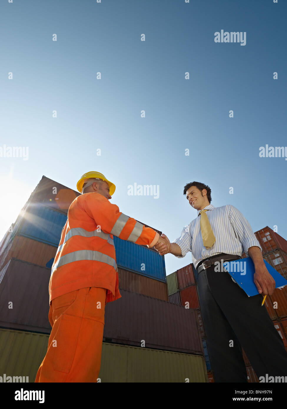 Two workers container shaking hands hi-res stock photography and images ...