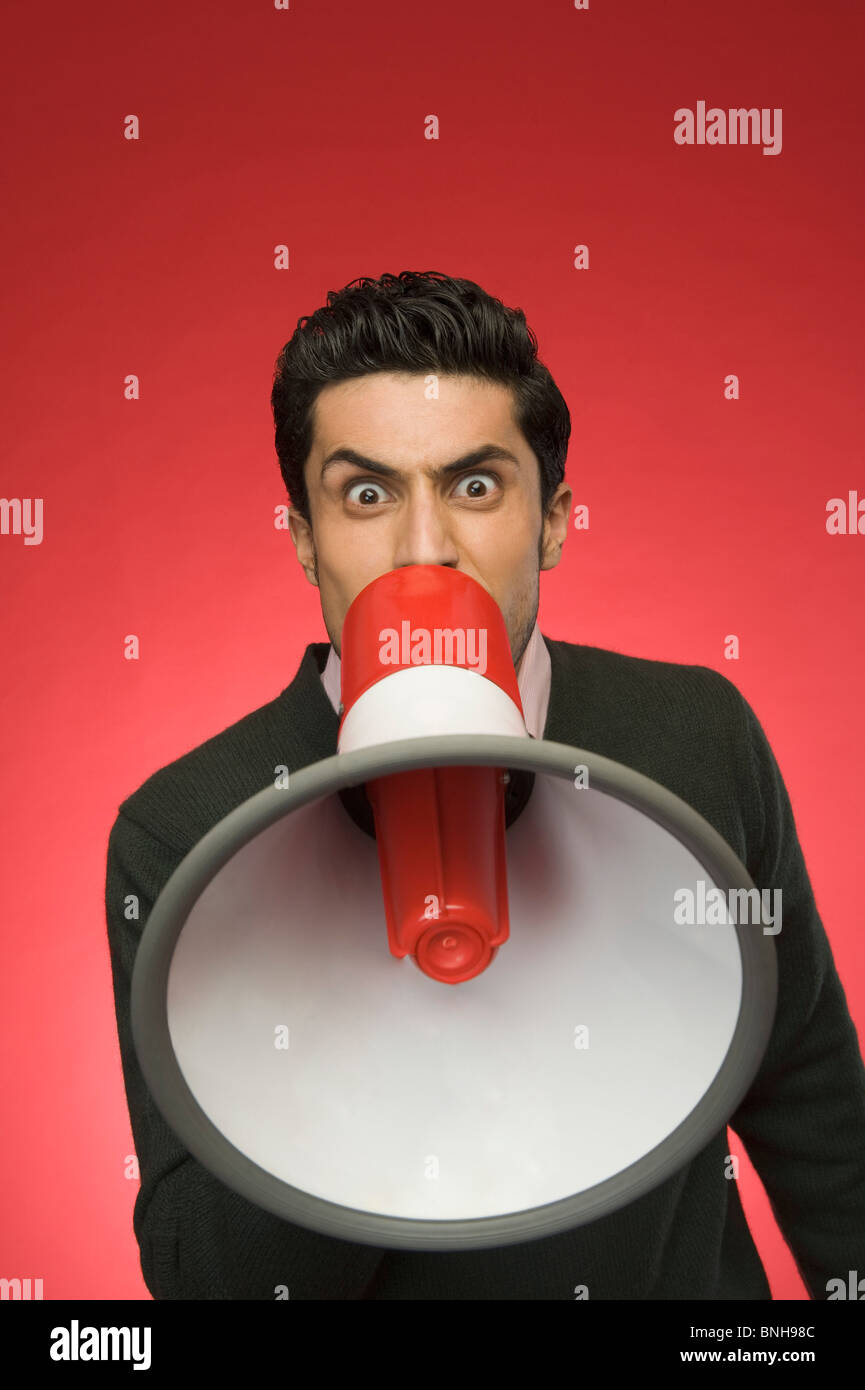 Businessman shouting into a megaphone Stock Photo - Alamy
