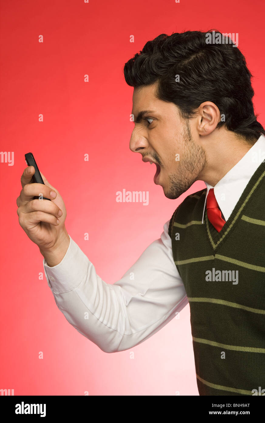 Businessman shouting on a mobile phone Stock Photo - Alamy