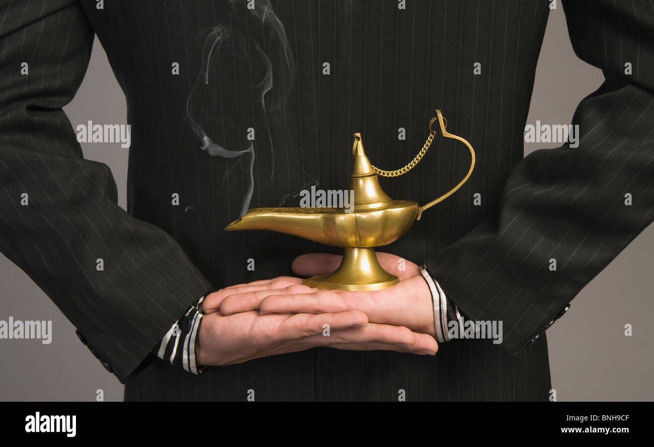 Mid section view of a businessman holding a magic lamp Stock Photo - Alamy
