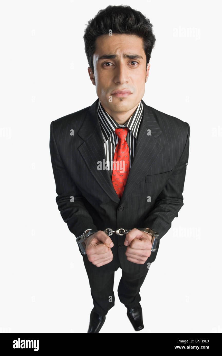 Portrait of a businessman tied up with handcuffs Stock Photo - Alamy