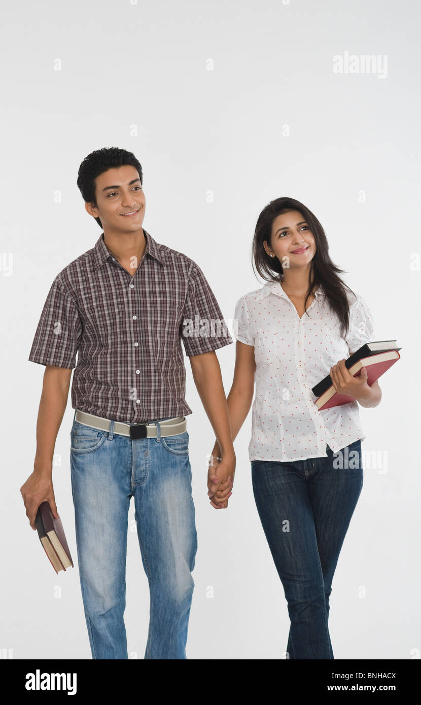College students walking with holding hands Stock Photo - Alamy