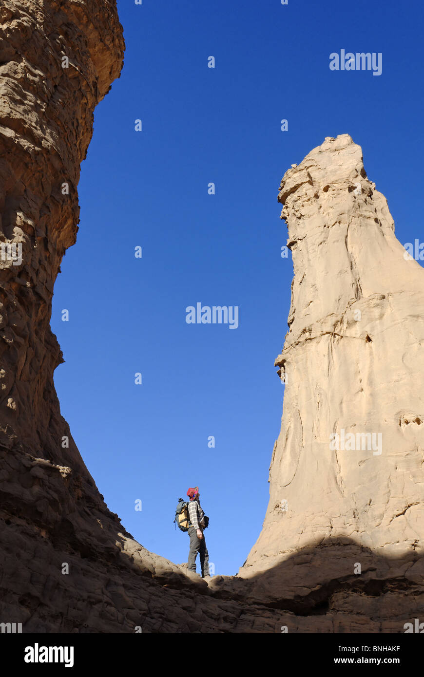 Algeria Sahara Hiker hiking rock cliff El Ghessour Tassili you Hoggar ...