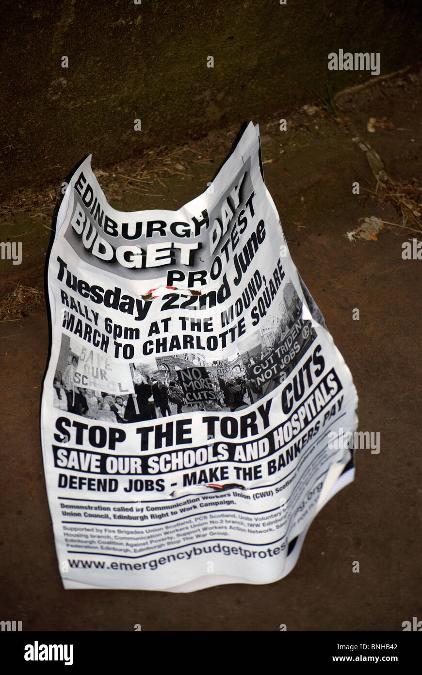 Discarded poster in Edinburgh, Scotland, advertising a march in protest ...