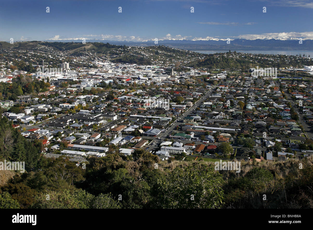 view of Nelson city centre New Zealand with blue sky and snow capped ...