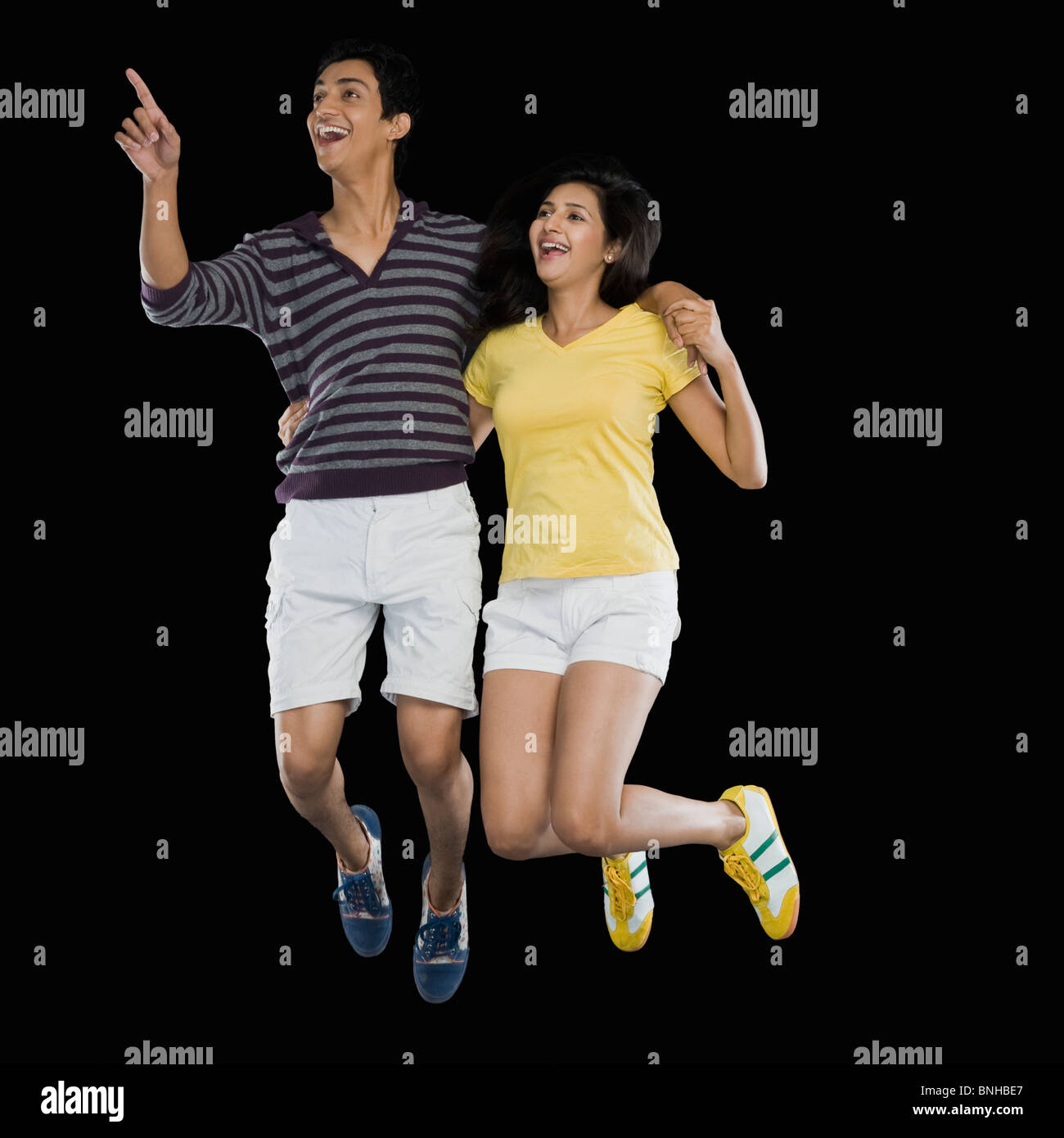 Man pointing woman jumping hi-res stock photography and images - Alamy