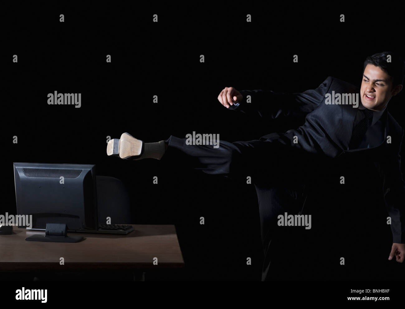 Frustrated businessman kicking a desktop pc Stock Photo - Alamy