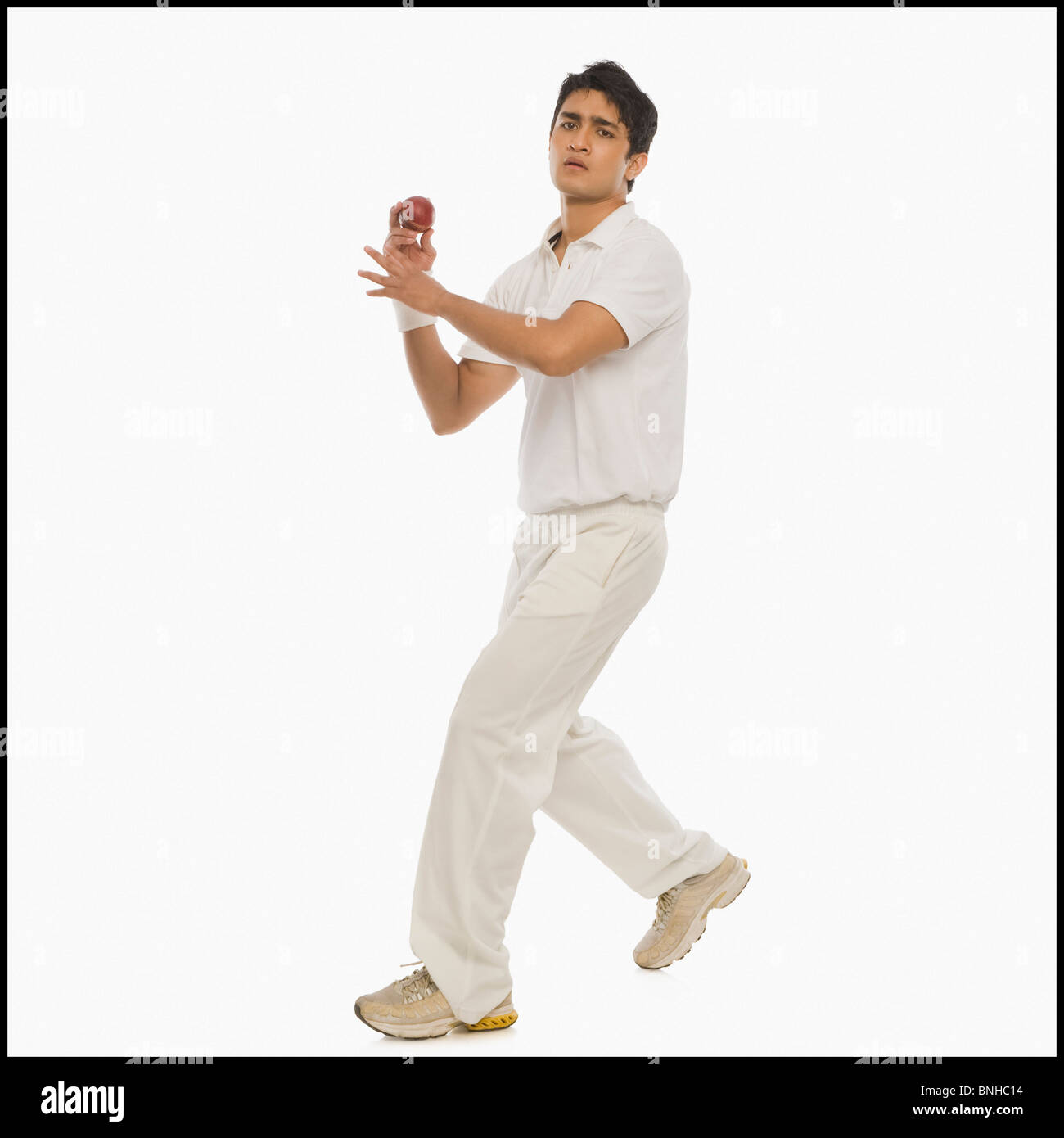 Cricket bowler in action Stock Photo - Alamy