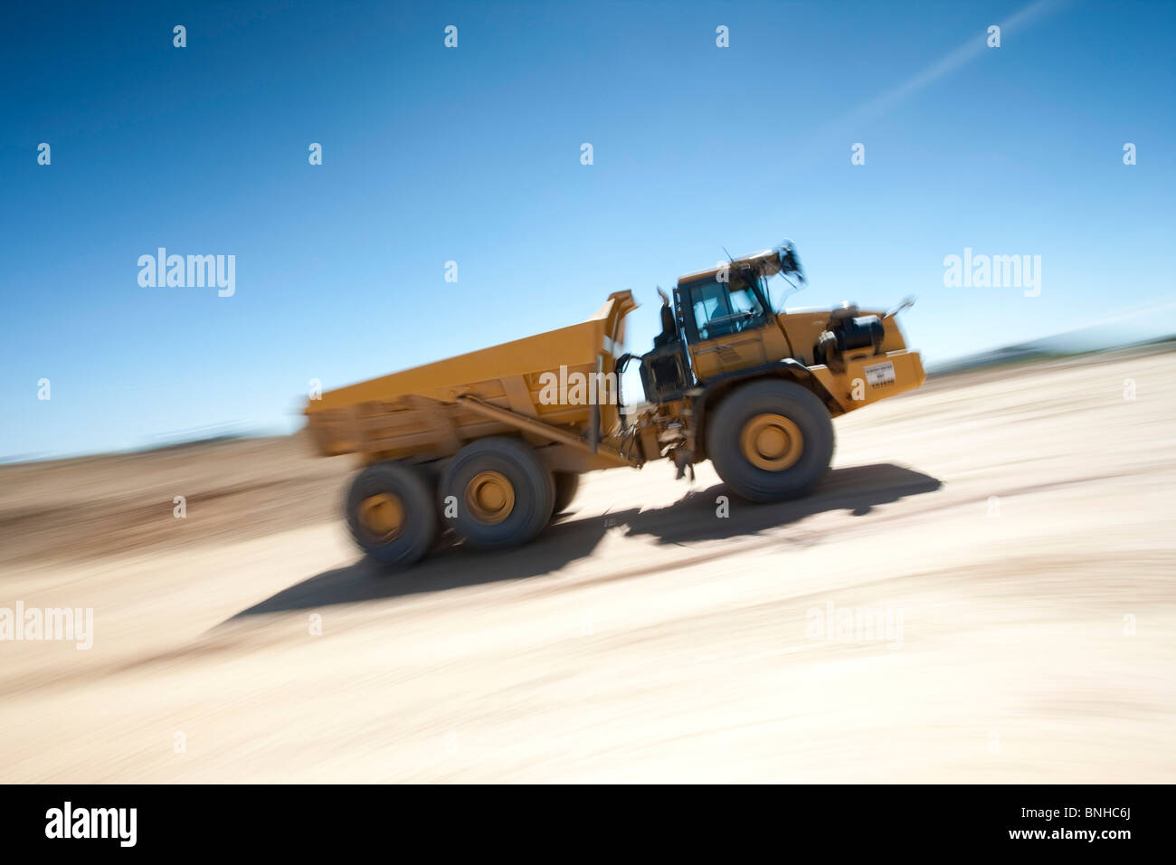 Articulated earth mover on road construction site Stock Photo - Alamy