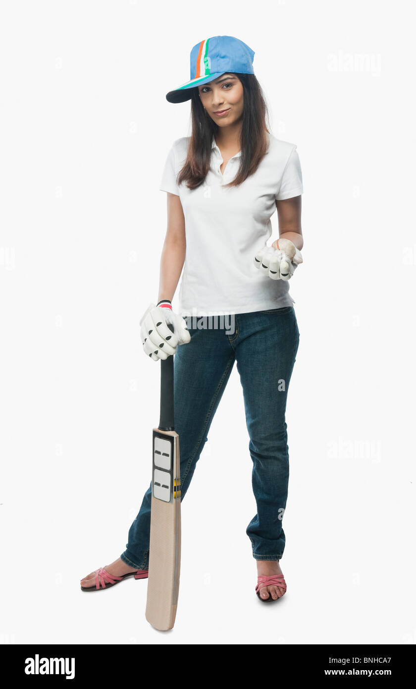 Portrait of a female cricket fan holding a bat and a ball Stock Photo ...