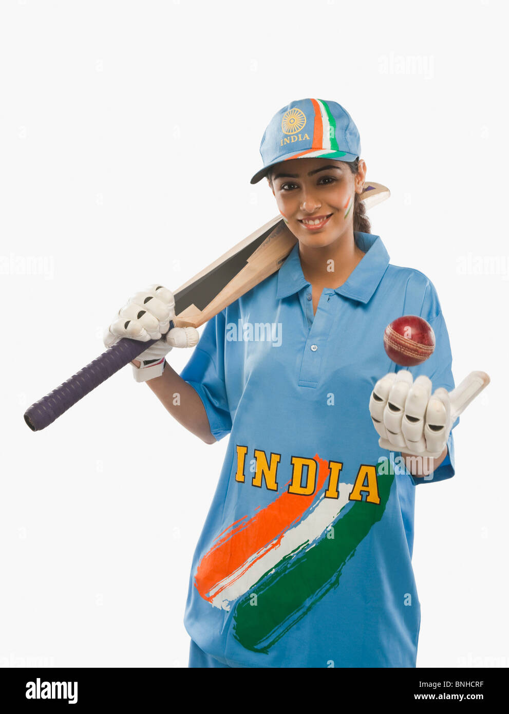 Portrait of a female cricketer tossing a cricket ball and smiling Stock ...