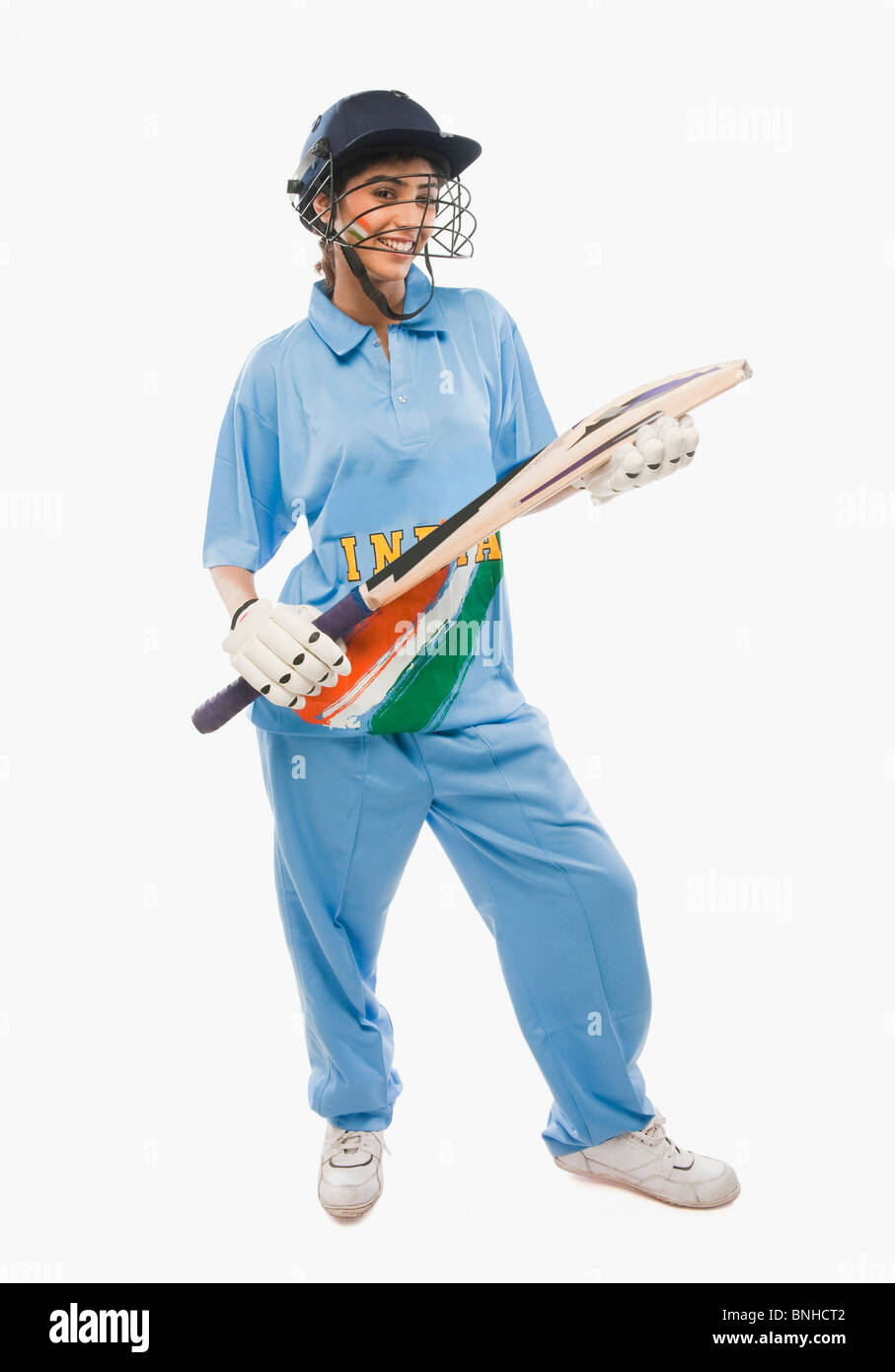 Portrait of a female cricketer holding a cricket bat Stock Photo - Alamy