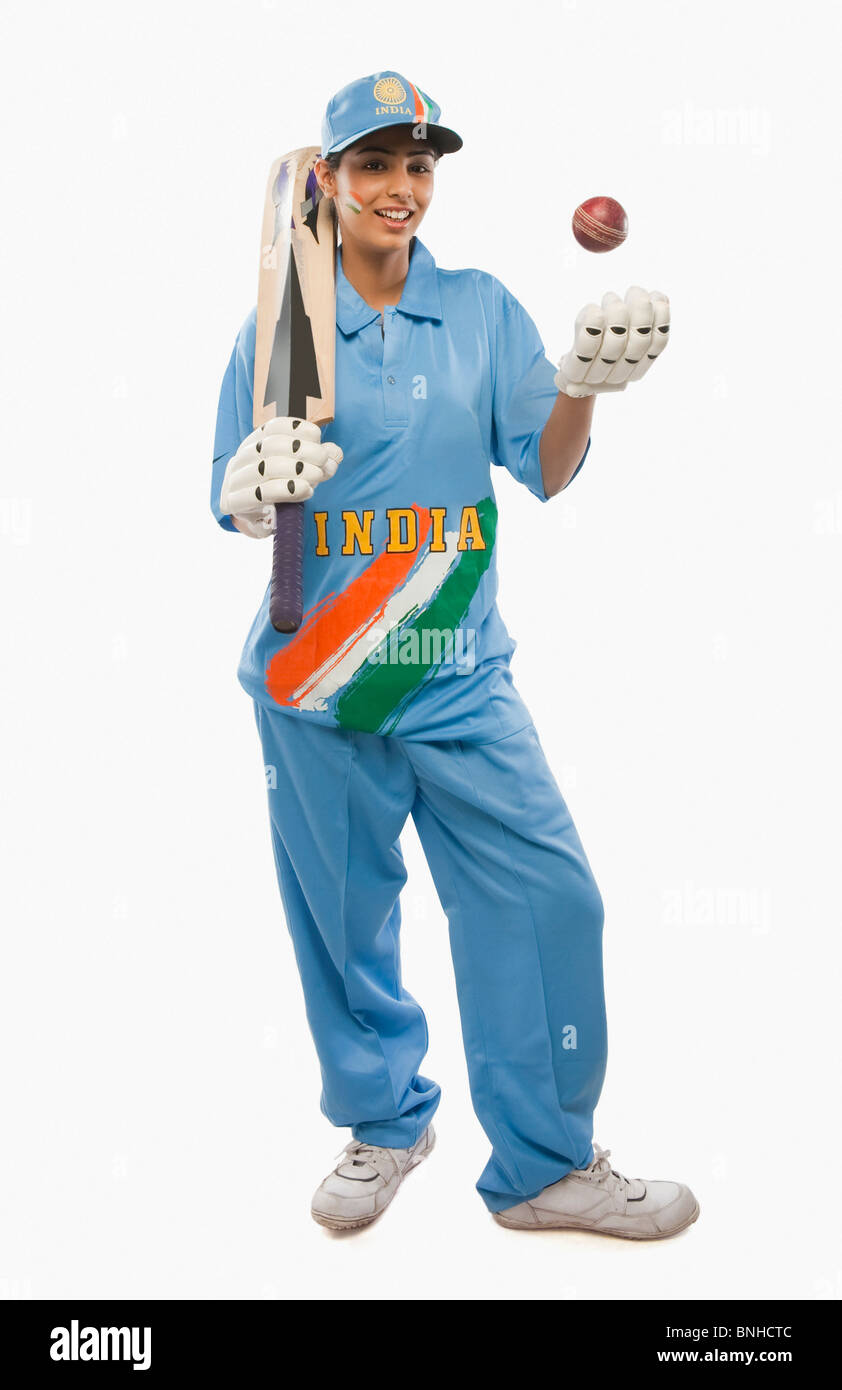 Portrait of a female cricketer tossing a cricket ball and smiling Stock ...
