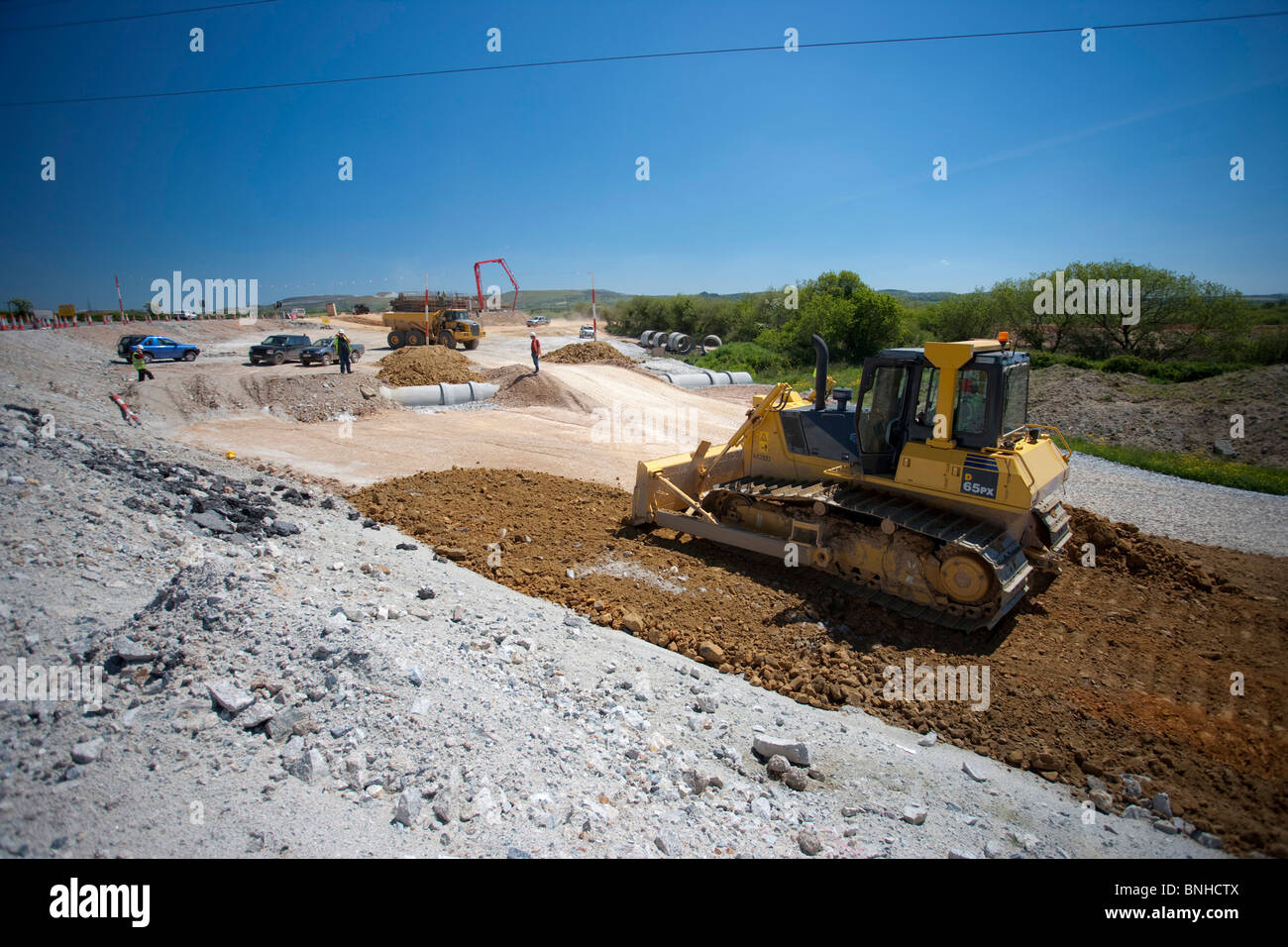 Bulldozer working on road construction site Stock Photo - Alamy