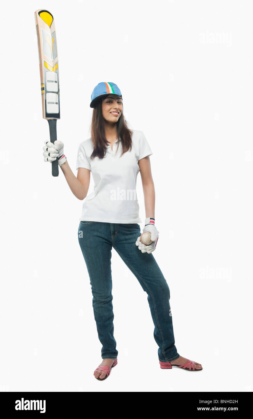 Portrait of a female cricket fan holding a bat and a ball Stock Photo ...