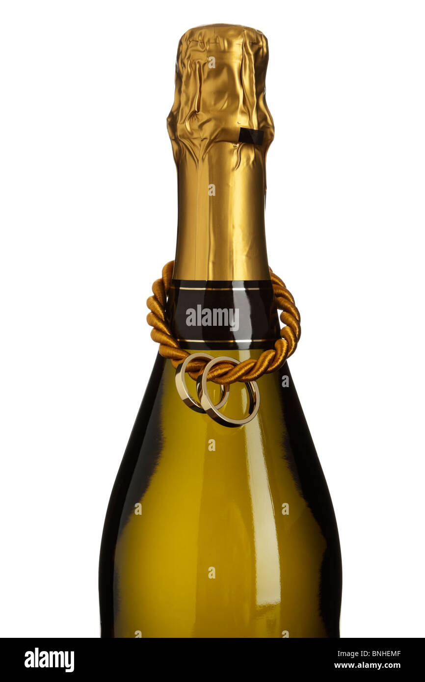 wedding rings attached to a champagne bottle with golden cordon Stock ...