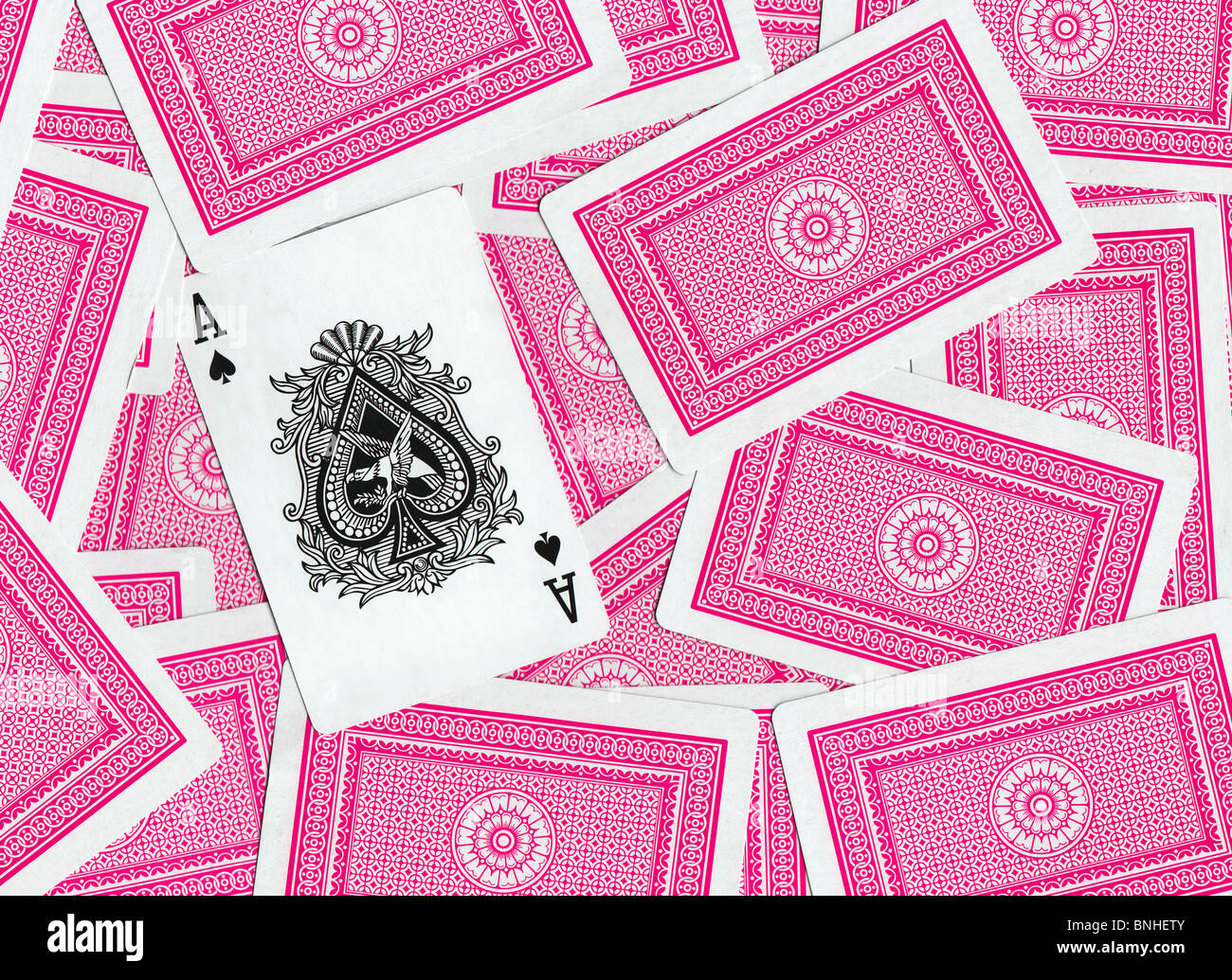 Lots of scattered playing cards, Ace of spades turned Stock Photo - Alamy