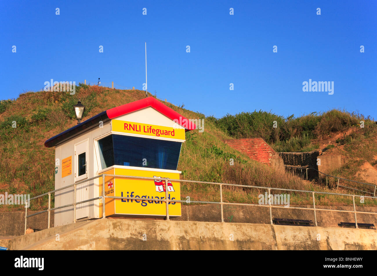 RNLI lifeguard hut on the sea wall at East Runton Gap, Norfolk, England ...