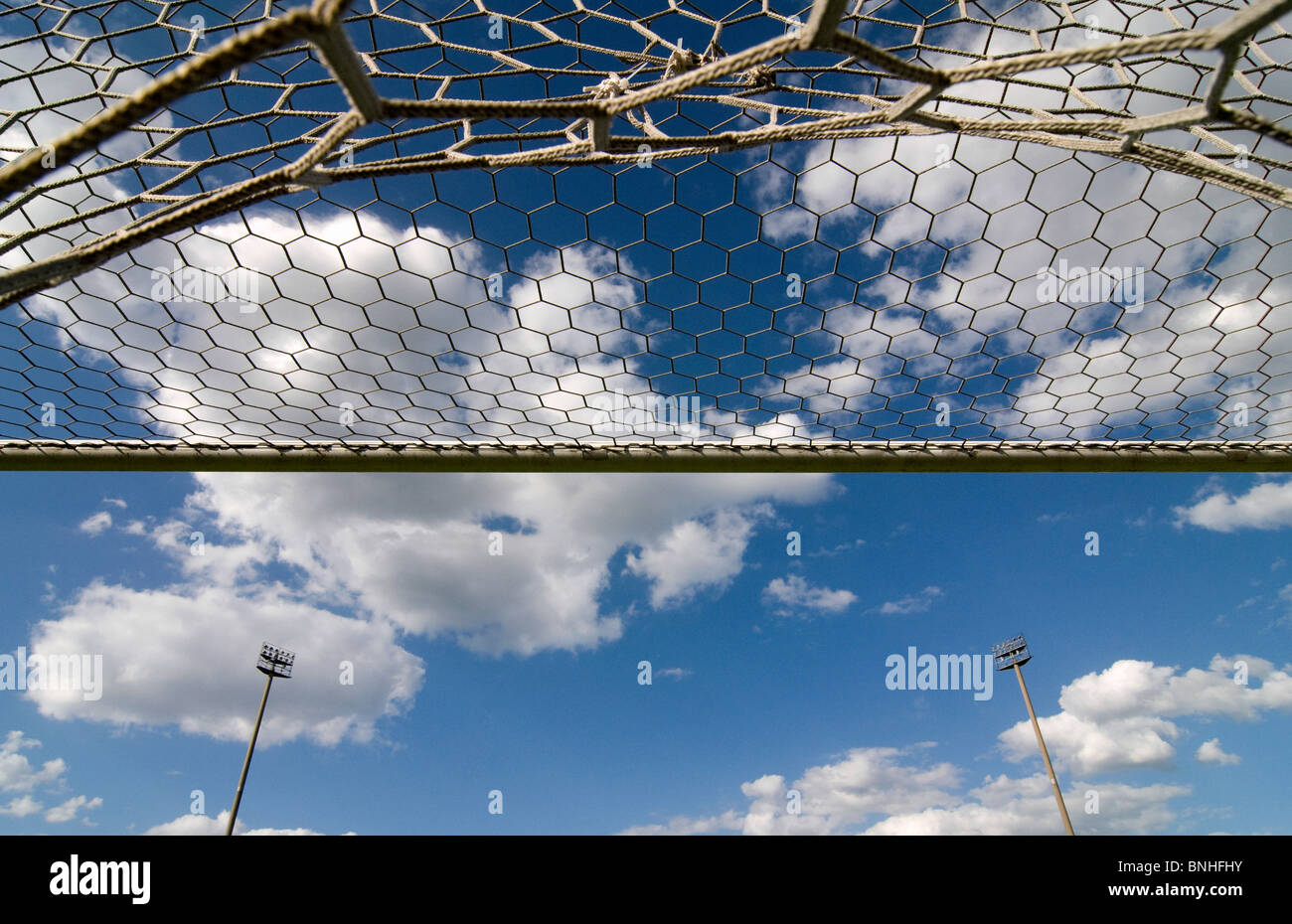 Detail of a football goal with blue sky and white clouds Stock Photo ...