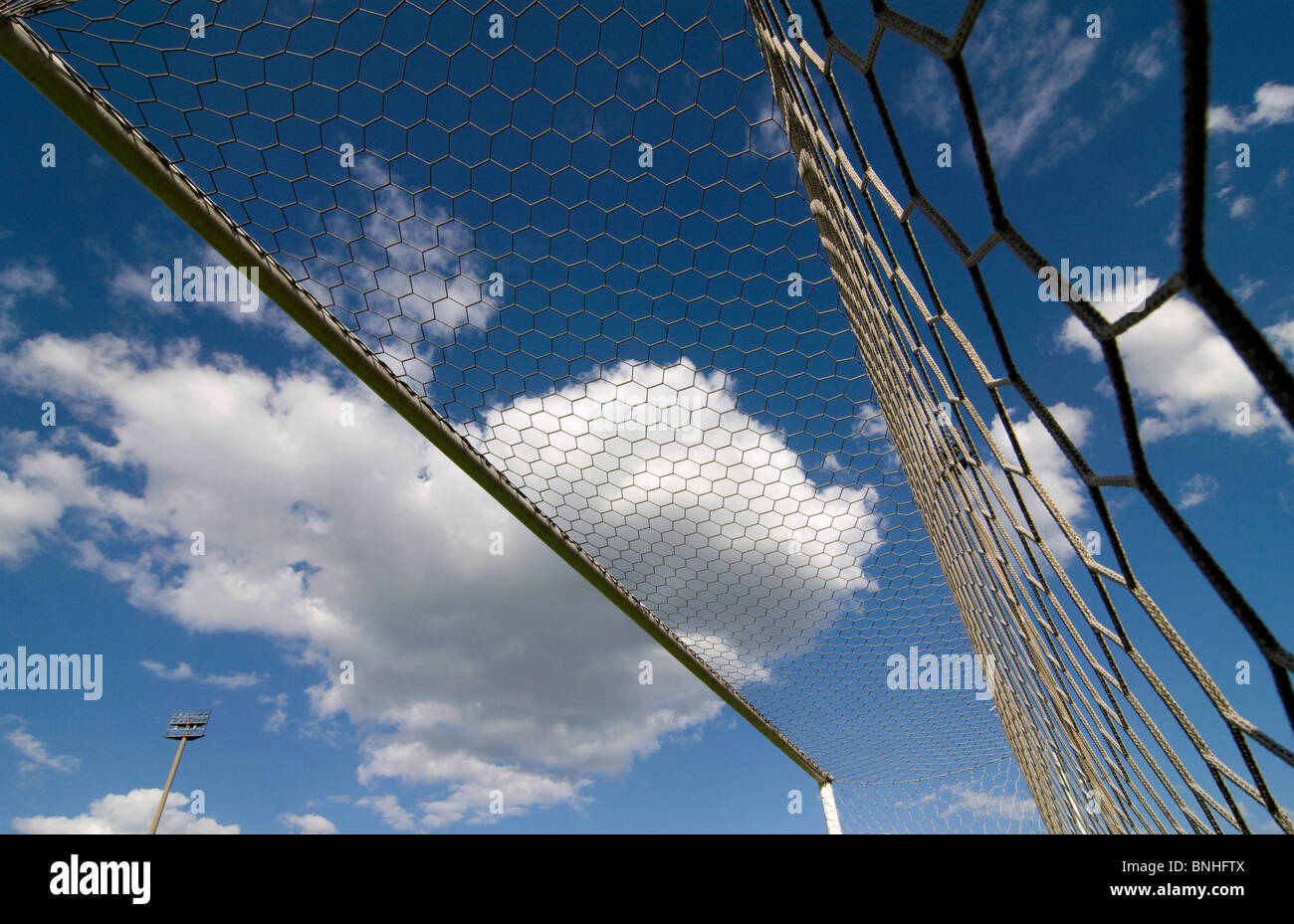 Detail of a football goal with blue sky and white clouds Stock Photo ...