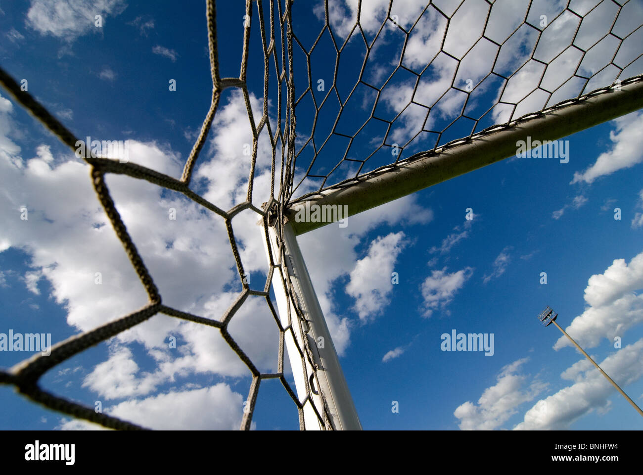 Detail of a football goal with blue sky and white clouds Stock Photo ...
