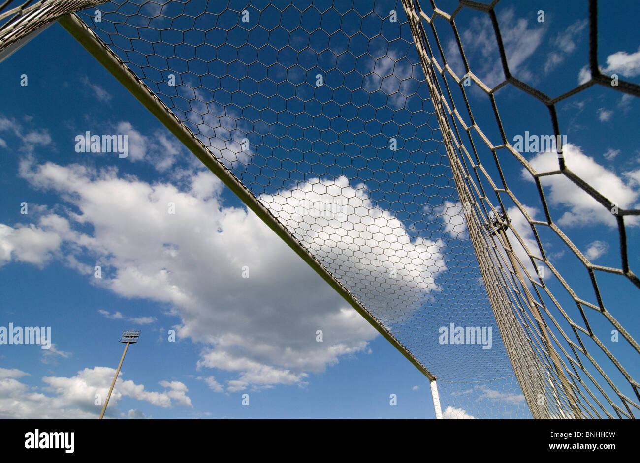 Detail of a football goal with blue sky and white clouds Stock Photo ...
