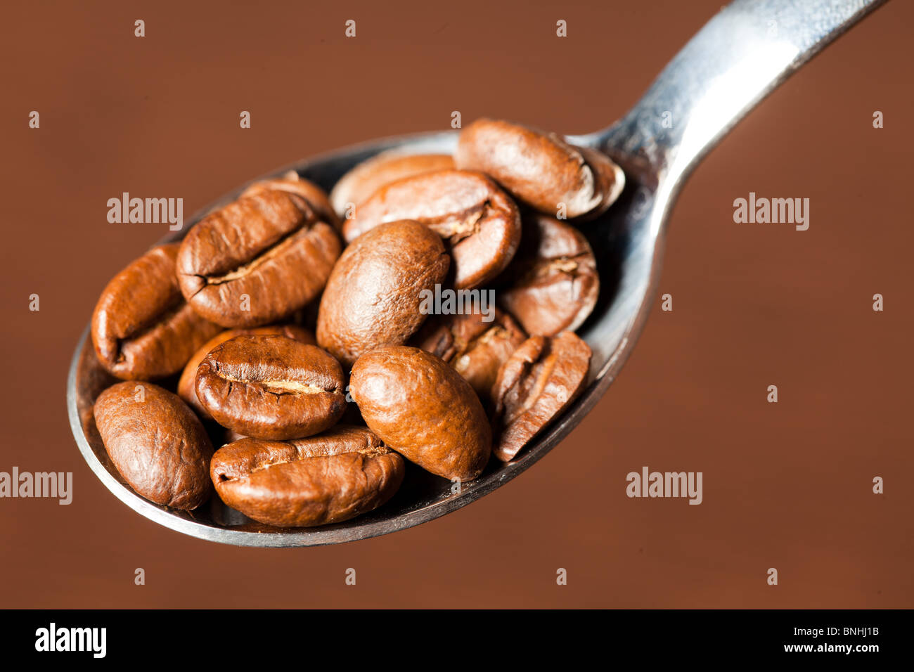 coffee beans on spoon Stock Photo - Alamy
