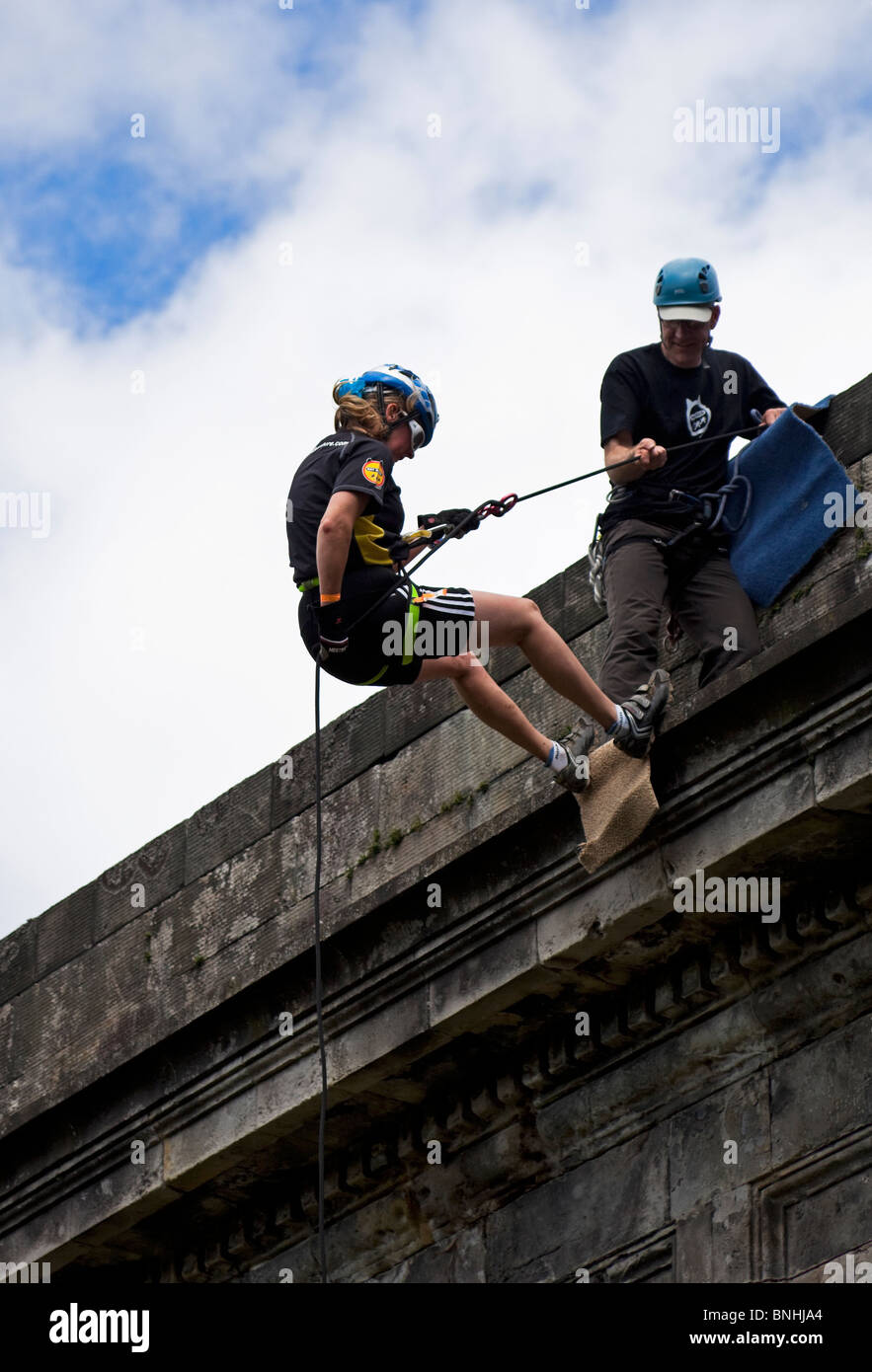 Female competitor in Rat Race Edinburgh abseiling from viaduct in ...