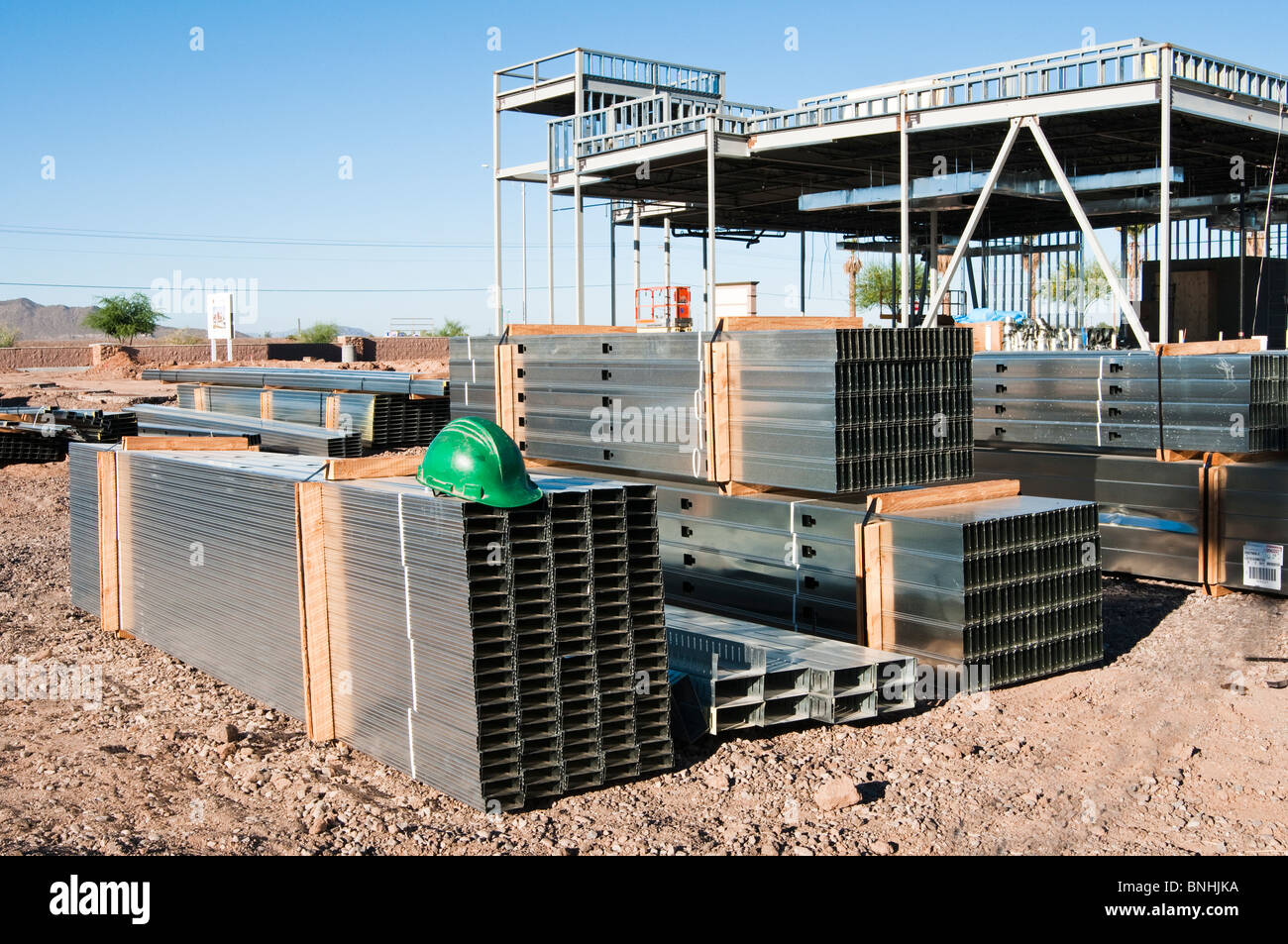 Steel beams are stacked on the construction site of a commercial ...