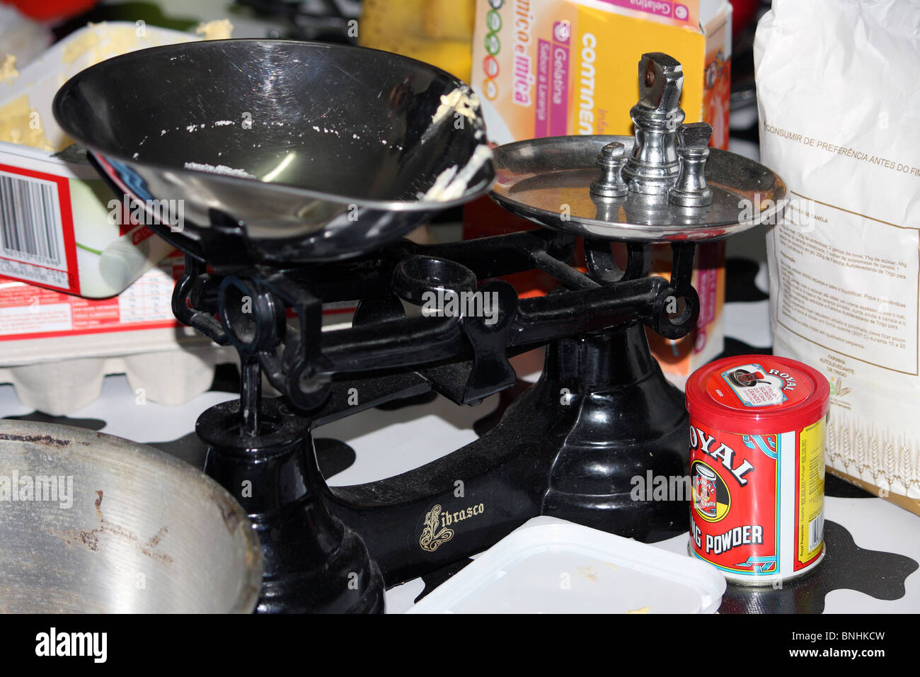A photograph showing baking ingredients and a set of weighing scales ...