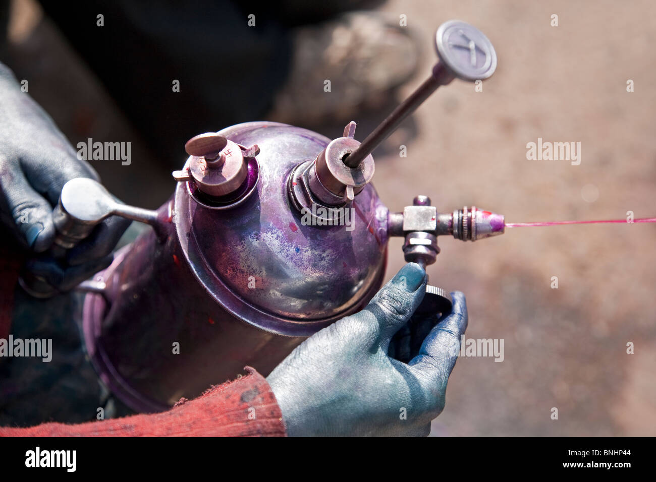 Kid using a water pump during Holi Festival. Varanasi (benares). India ...